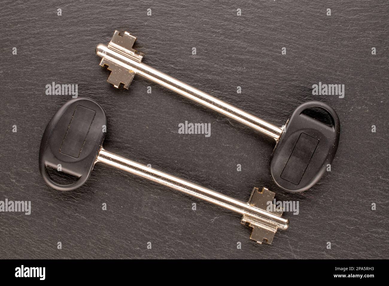 Two metal keys from a door lock on slate stone, macro, top view Stock ...