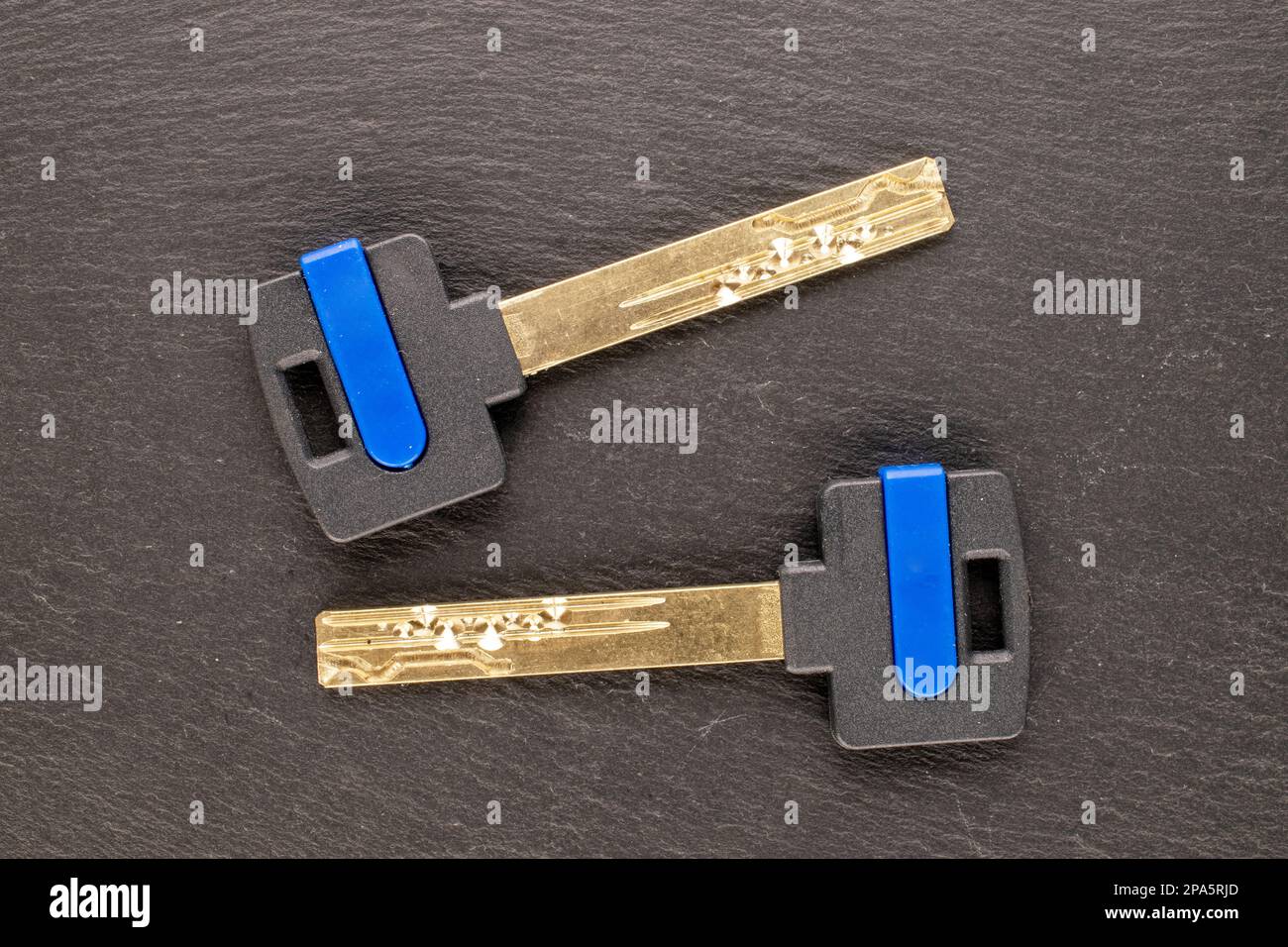 Two metal keys from a door lock on slate stone, macro, top view Stock ...