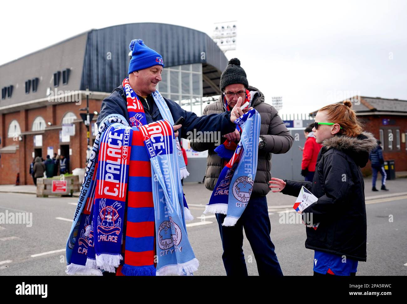 A street vendor sells commemorative match scarves outside of the ...