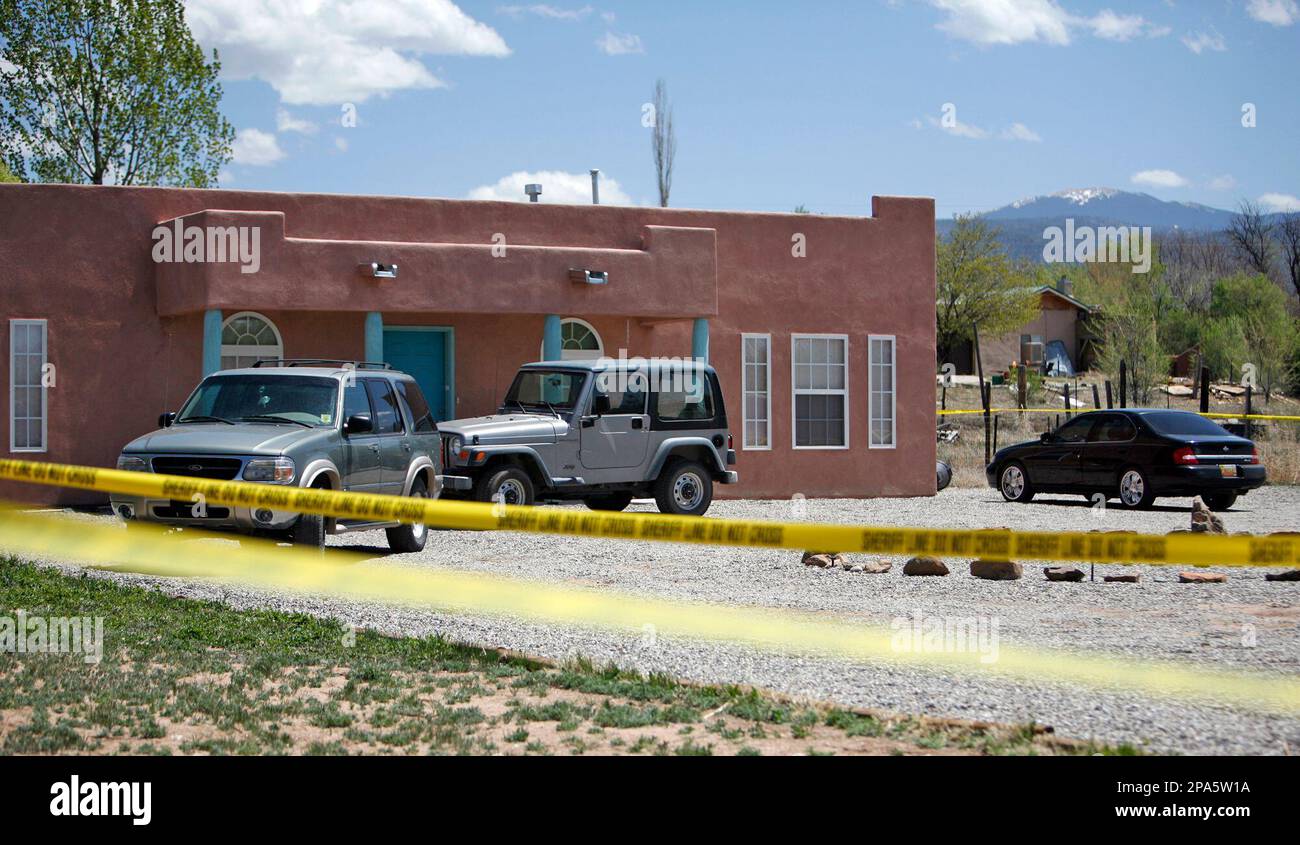 Police tape surrounds the scene of a homicide in Nambe, N.M., on ...