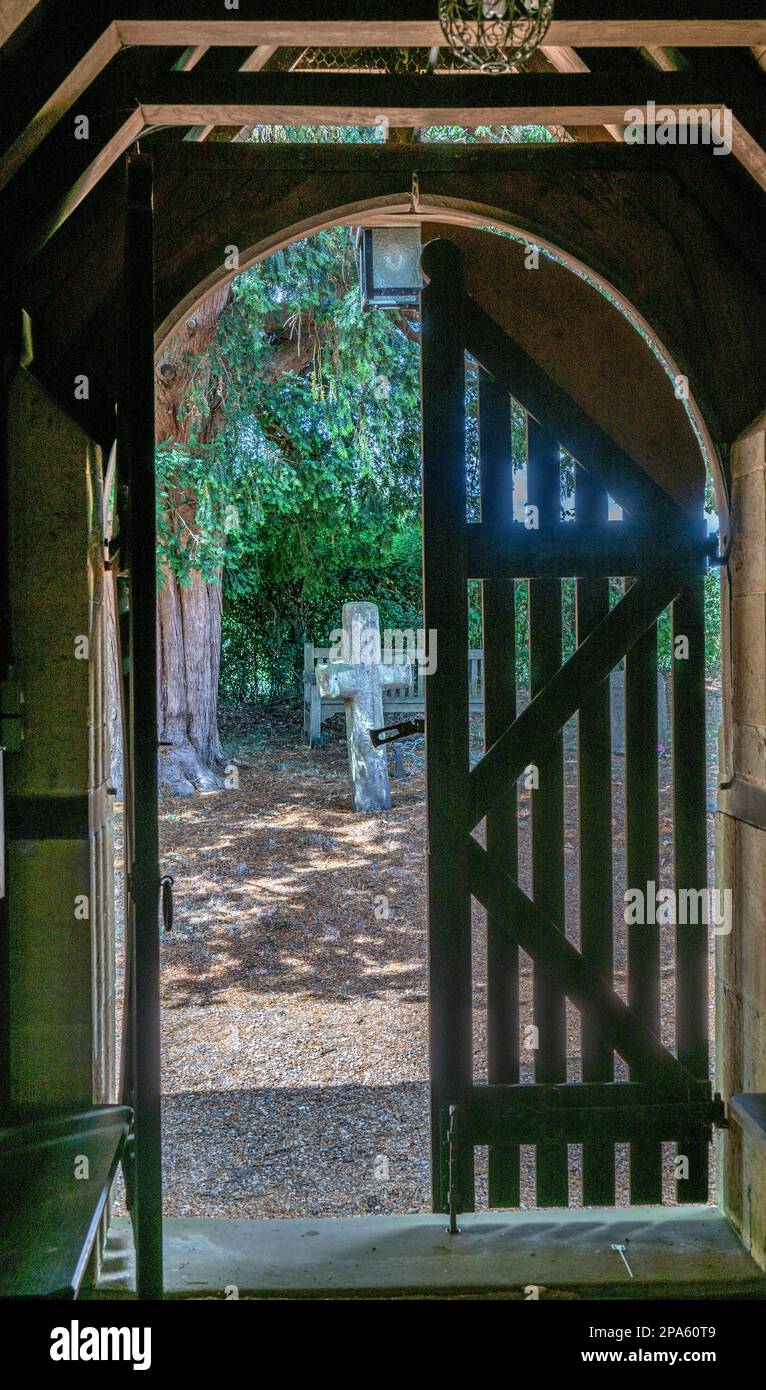 A view of a gravestone through the church doors of St Peter's church ...