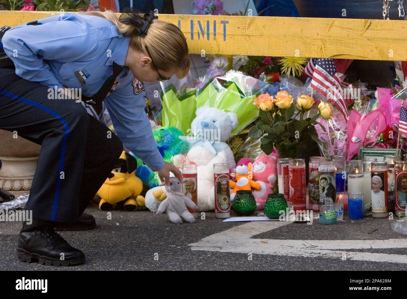 Officer Susan Pollick places a stuffed animal at a memorial for Sgt ...