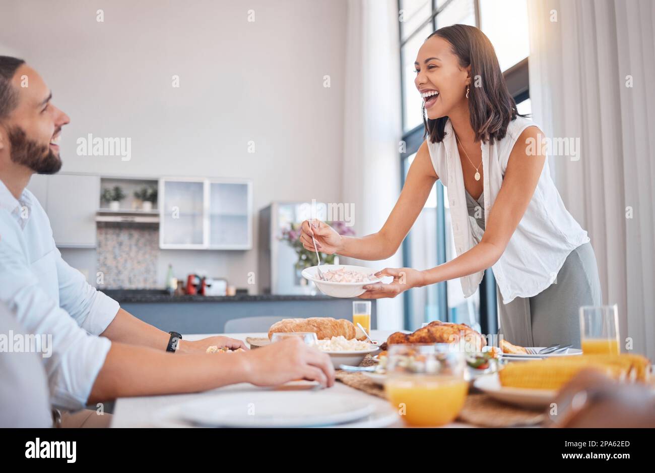 Happy, smile and couple eating dinner together at the dining room table ...