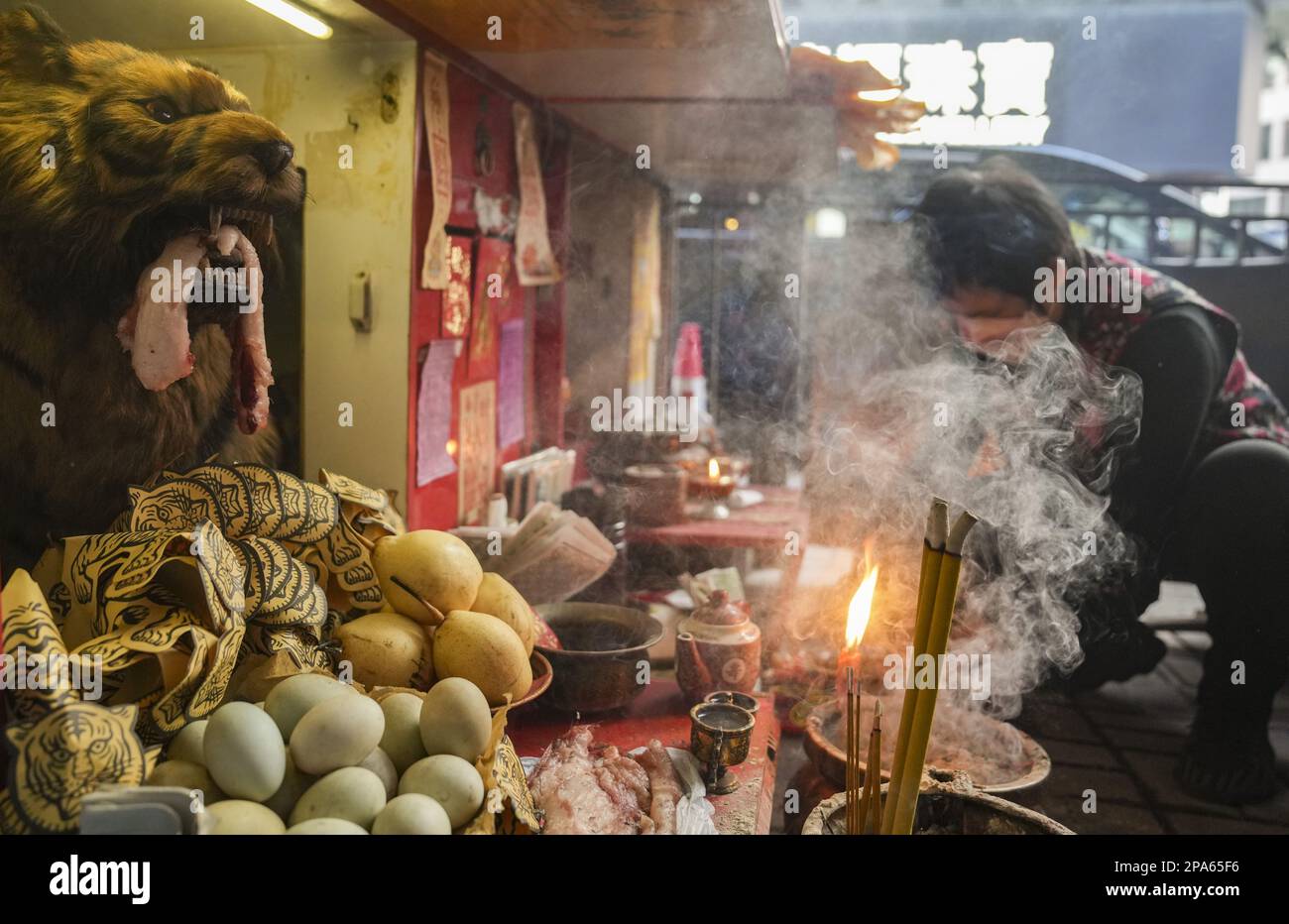 People performs a 'villain hitting' ceremony under the Canal Road ...