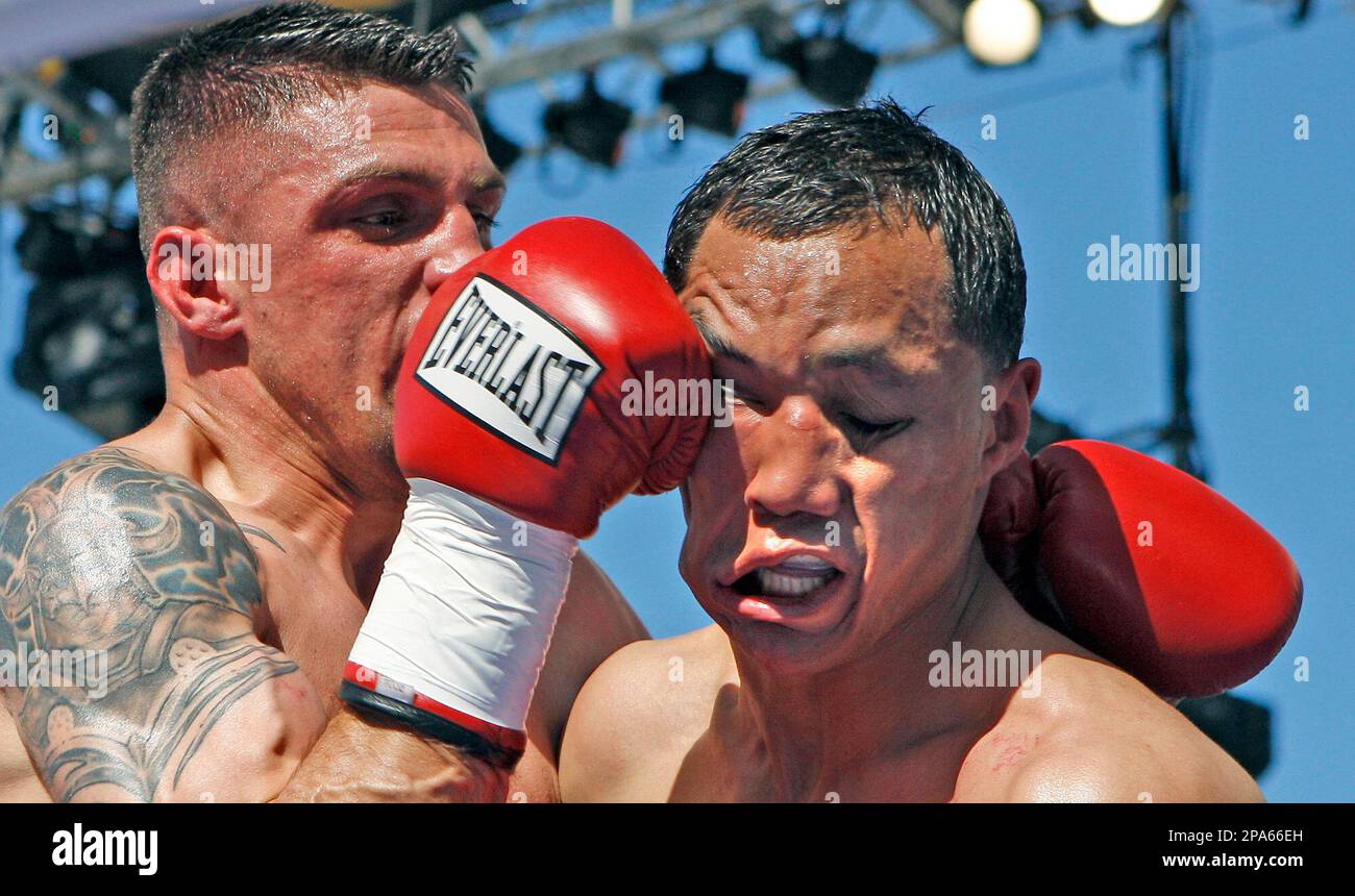 Sven Paris, left, of Italy, lands a punch on Freddy Curiel during a ...