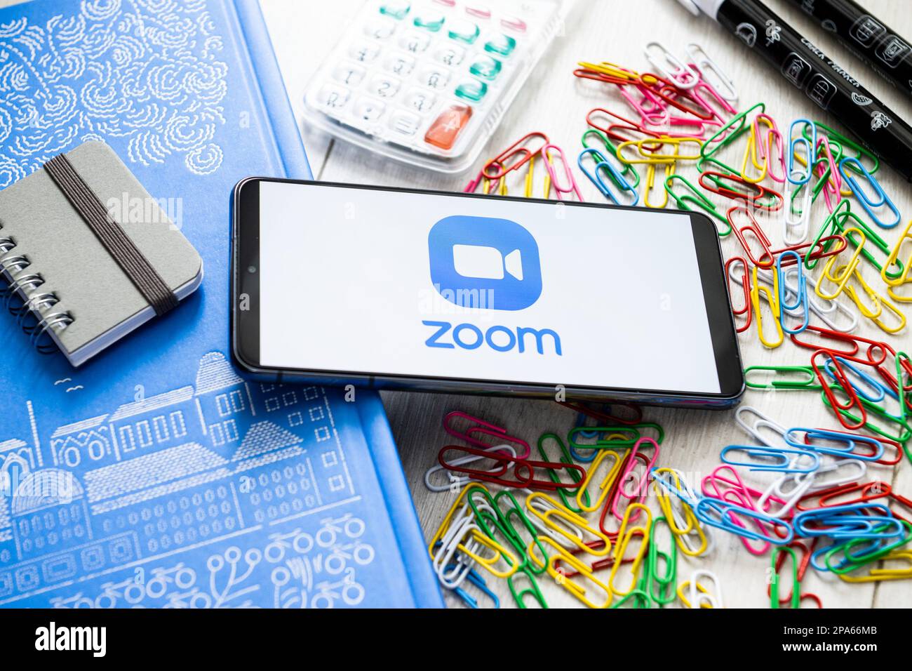 In this photo illustration a Zoom logo seen displayed on a smartphone ...