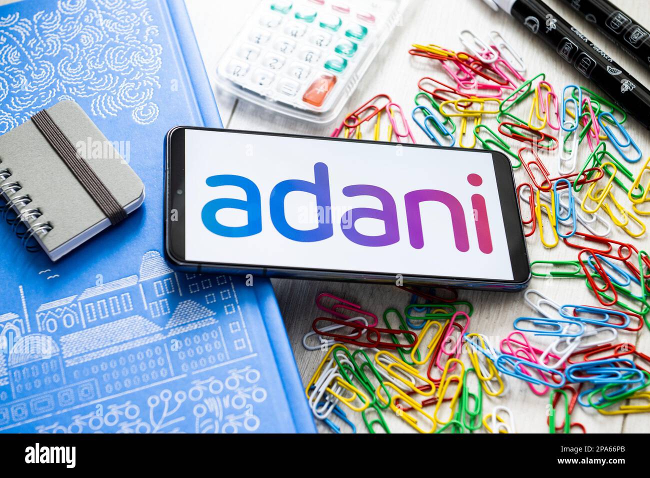 In this photo illustration an Adani logo seen displayed on a smartphone ...