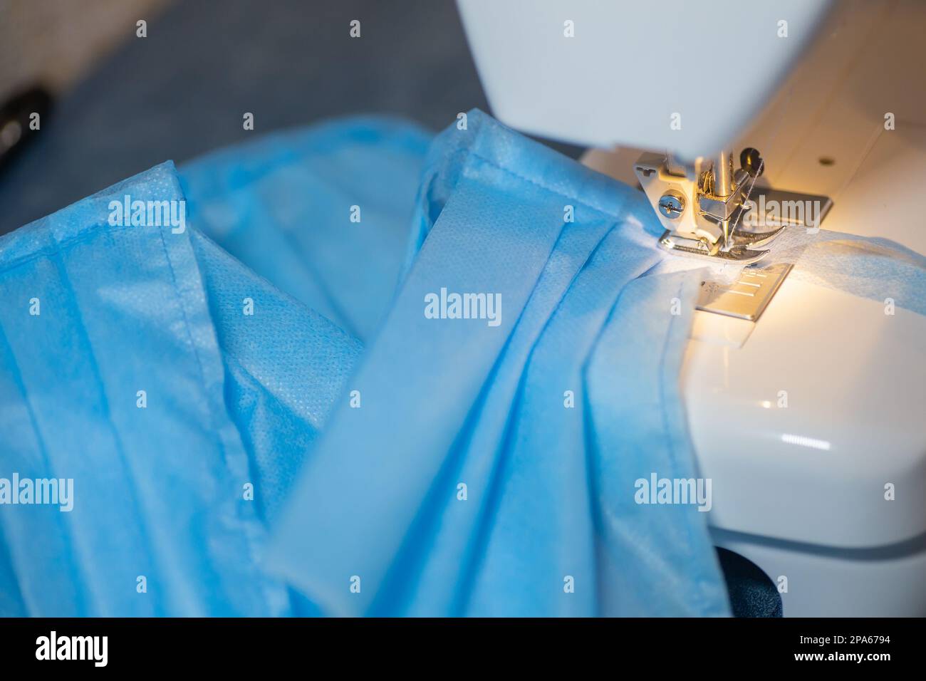 Details of electric sewing machine. Hand-stitching medical masks at ...