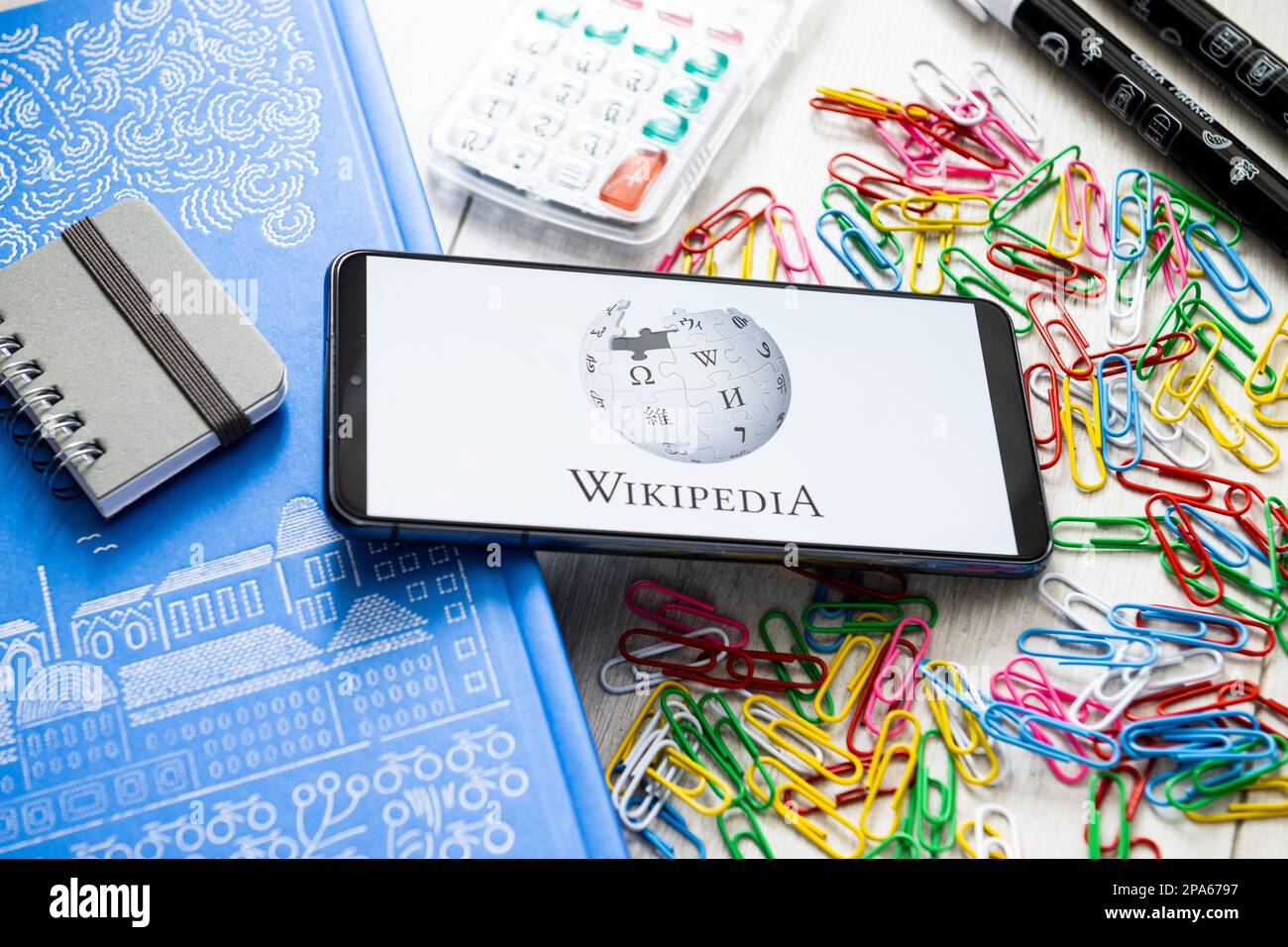 In this photo illustration a Wikipedia logo seen displayed on a ...