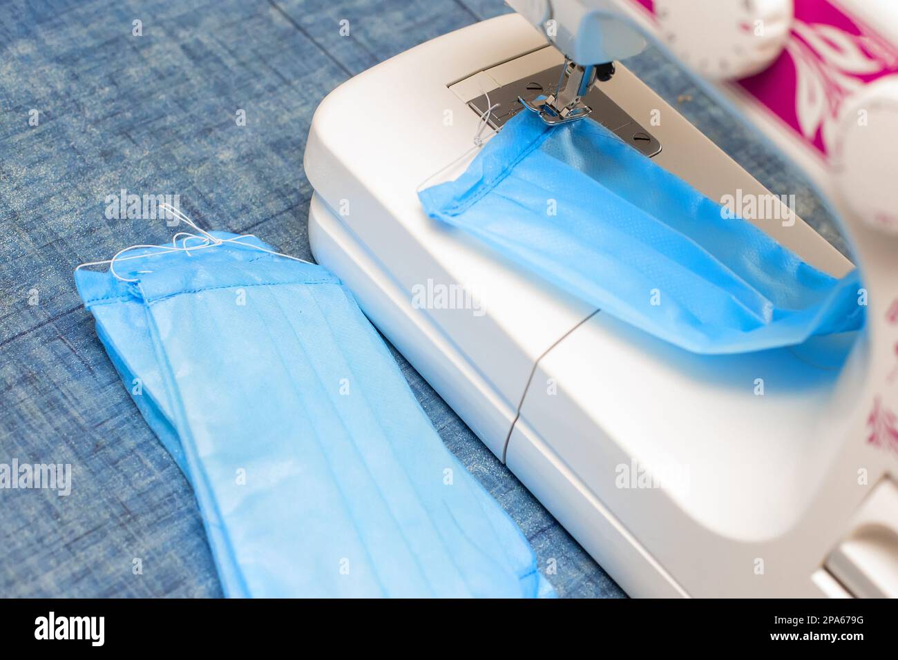 Details of electric sewing machine. Hand-stitching medical masks at ...