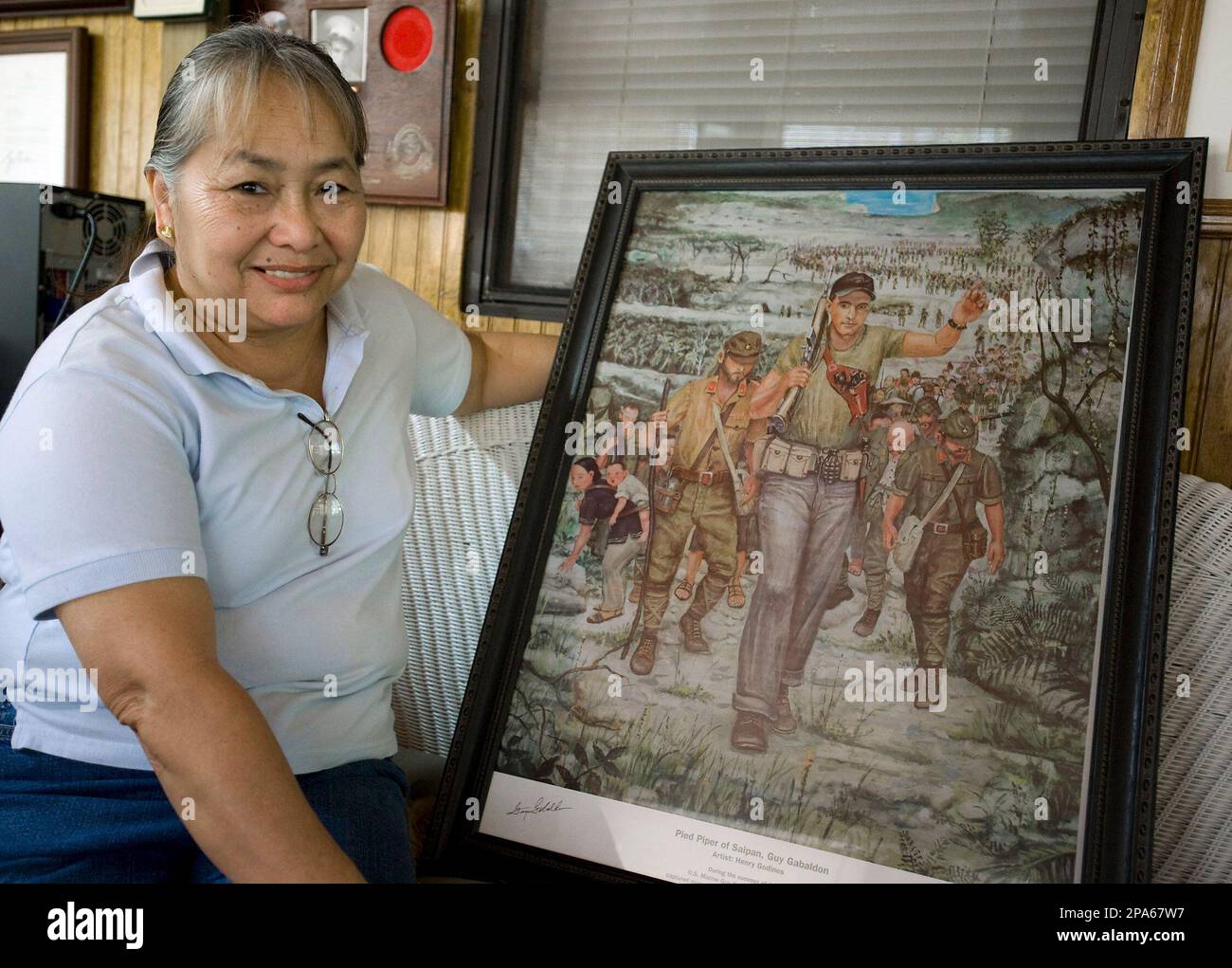 Ohana Gabaldon holds a painting depicting her deceased husband, Guy, as ...