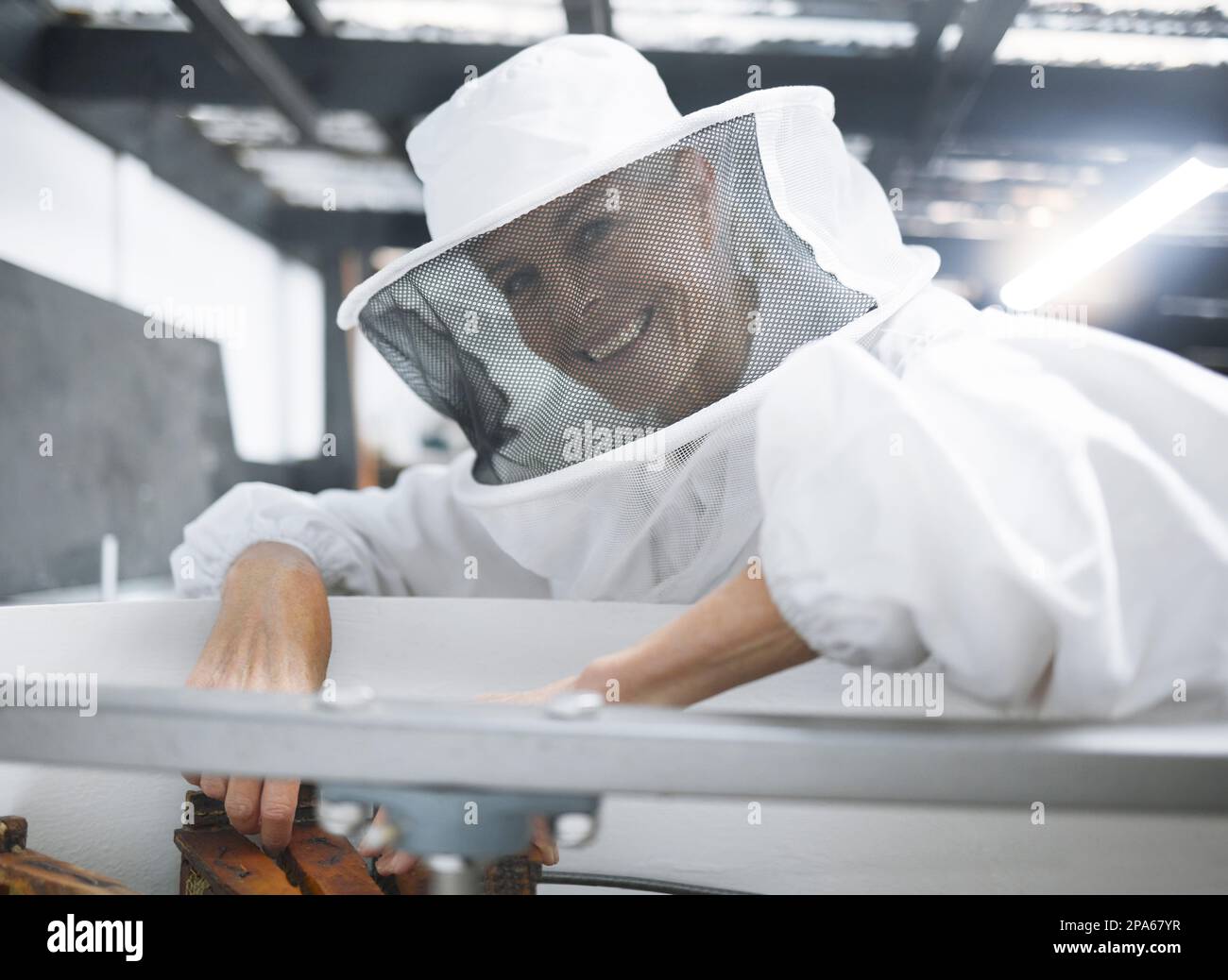 Woman, beekeeper suit and honey production, manufacturing and process ...