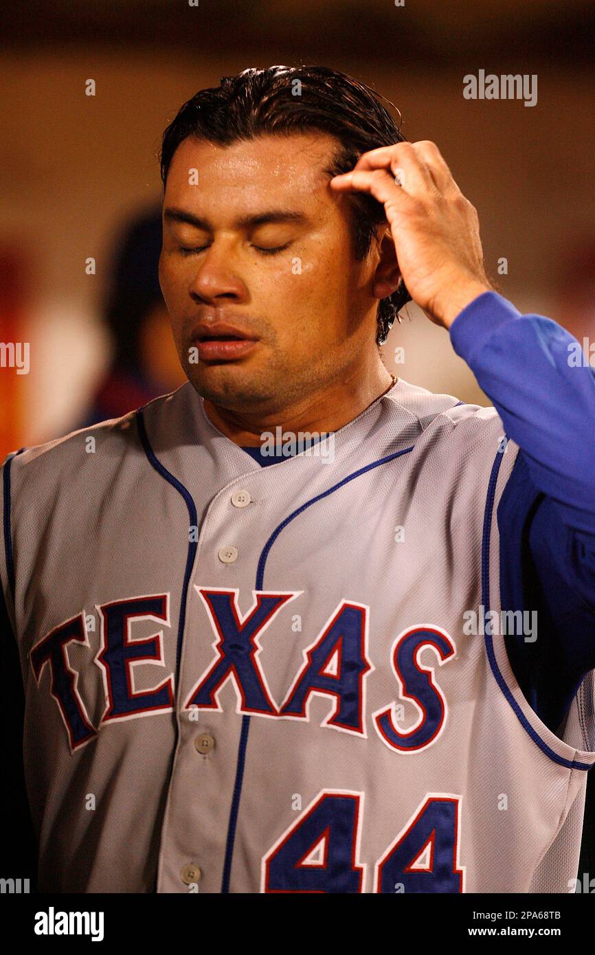 Texas Rangers starting pitcher Vicente Padilla reacts after being taken ...