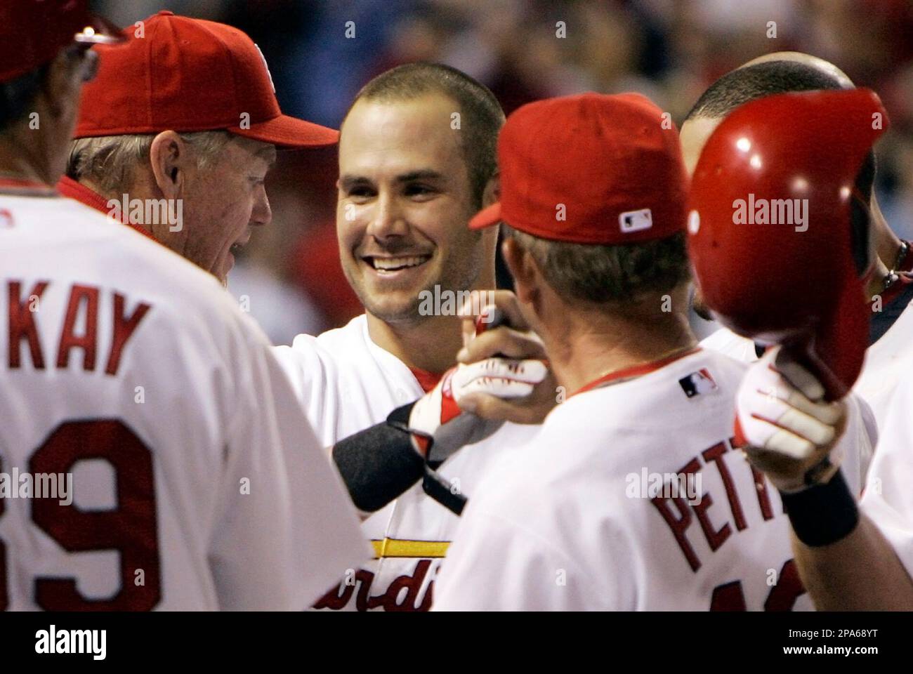 St. Louis Cardinals' Skip Schumaker, center, smiles as he is ...