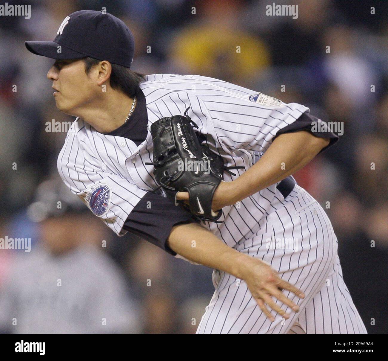 New York Yankees' Chien-Ming Wang follows through on a pitch against ...
