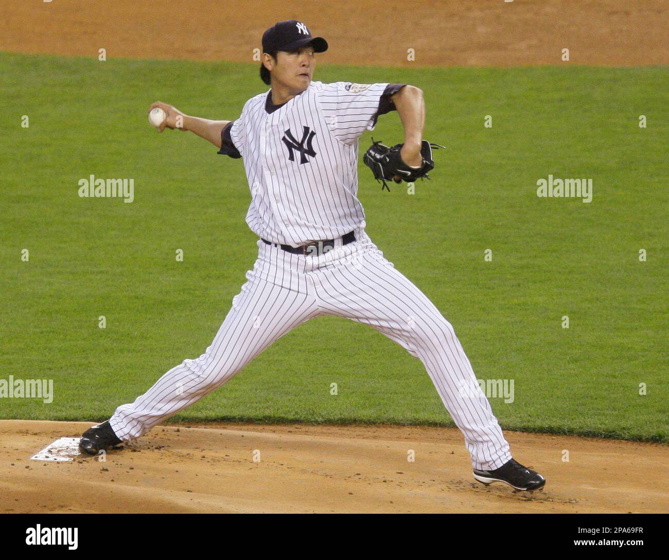 New York Yankees' Chien-Ming Wang delivers against the Seattle Mariners ...