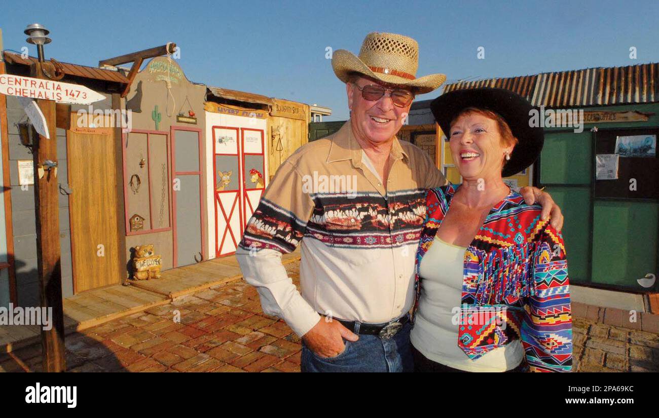 Bill and Lola Scamahorn stand in their backyard surrounded by facades ...