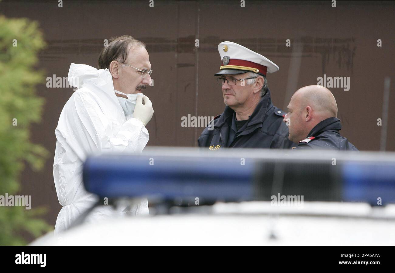 Members of the Austrian police are seen in the backyard of a house in ...