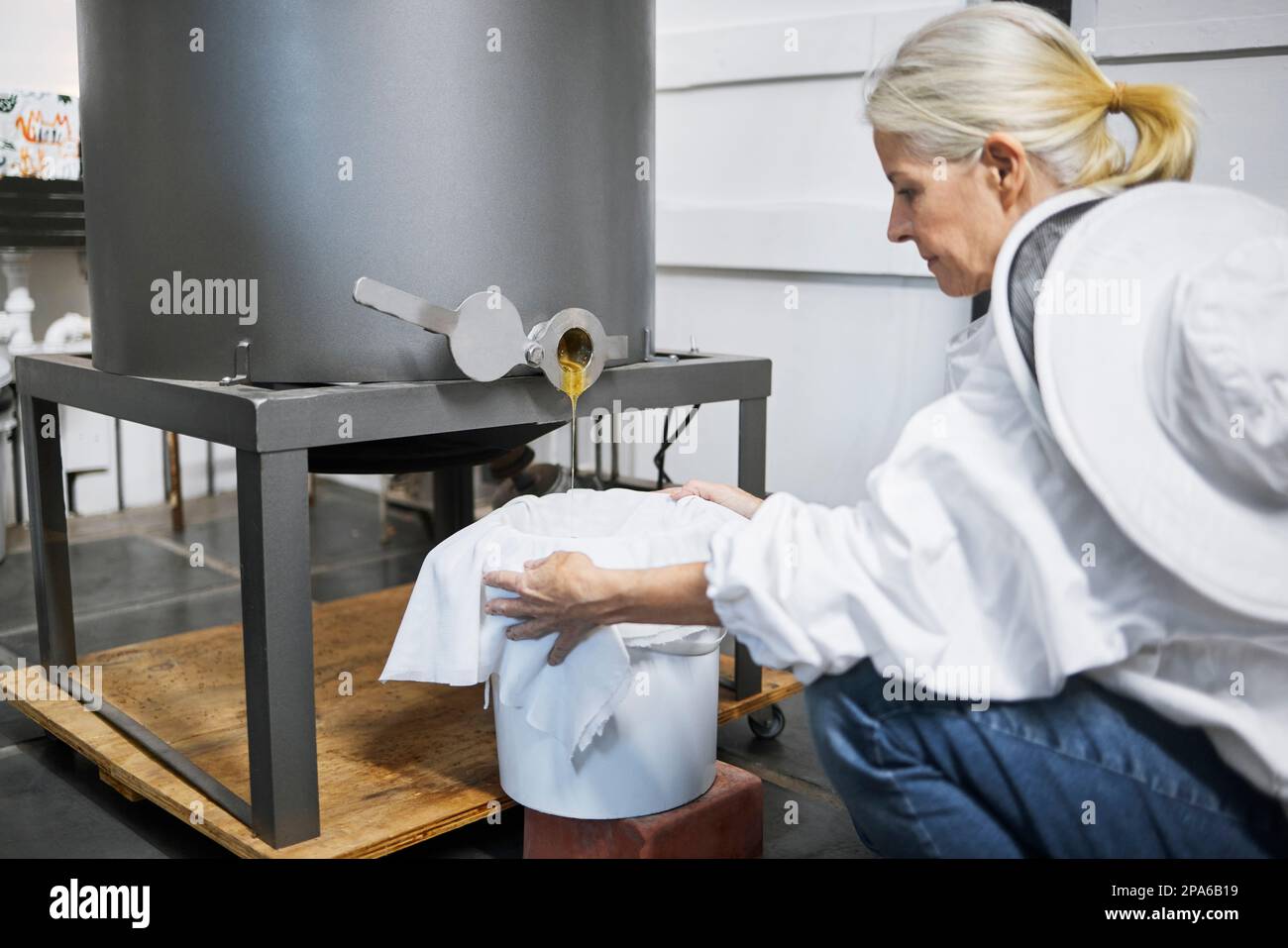 Beekeeper woman, honey production and machine in factory, workshop and ...