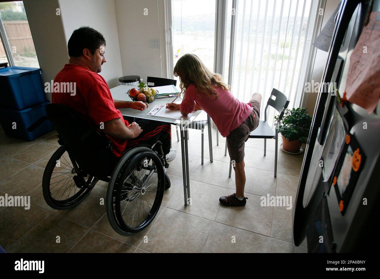 **ADVANCE FOR TUESDAY, MAY 6** John Pou, left, helps his daughter Kacie ...