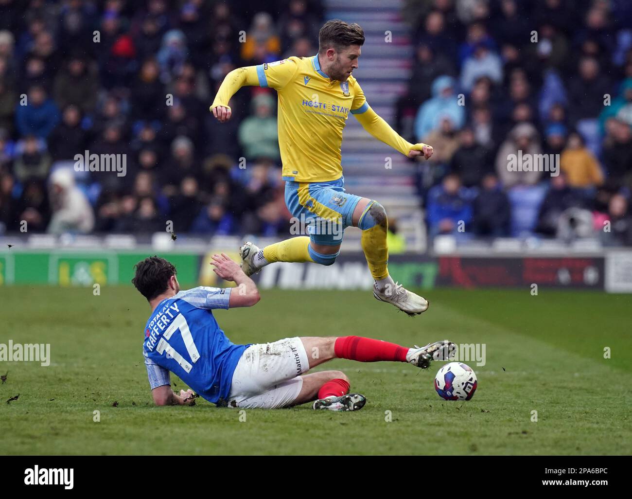 Sheffield Wednesday's Josh Windass (top) is challenged by Portsmouth's ...