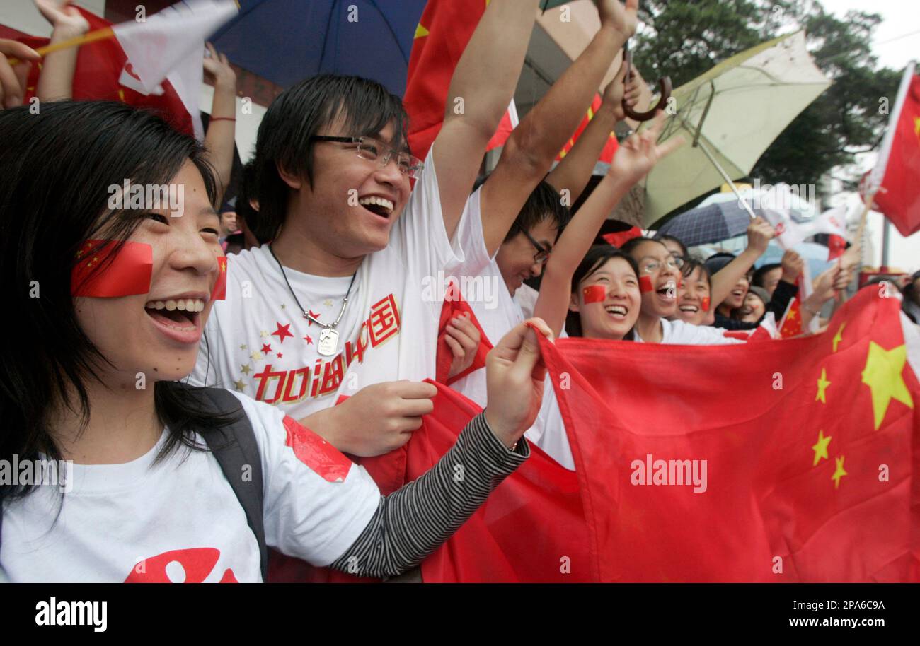 Chinese university students cheer during the Olympic torch relay in ...
