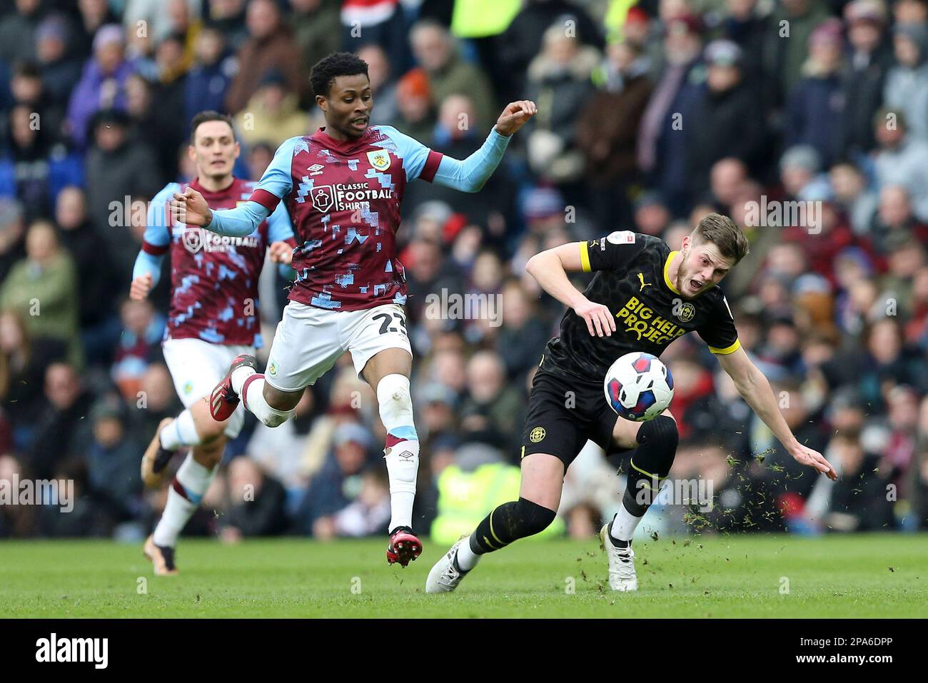 Burnley, UK. 11th Mar, 2023. Tom Pearce of Wigan Athletic (r) passes ...