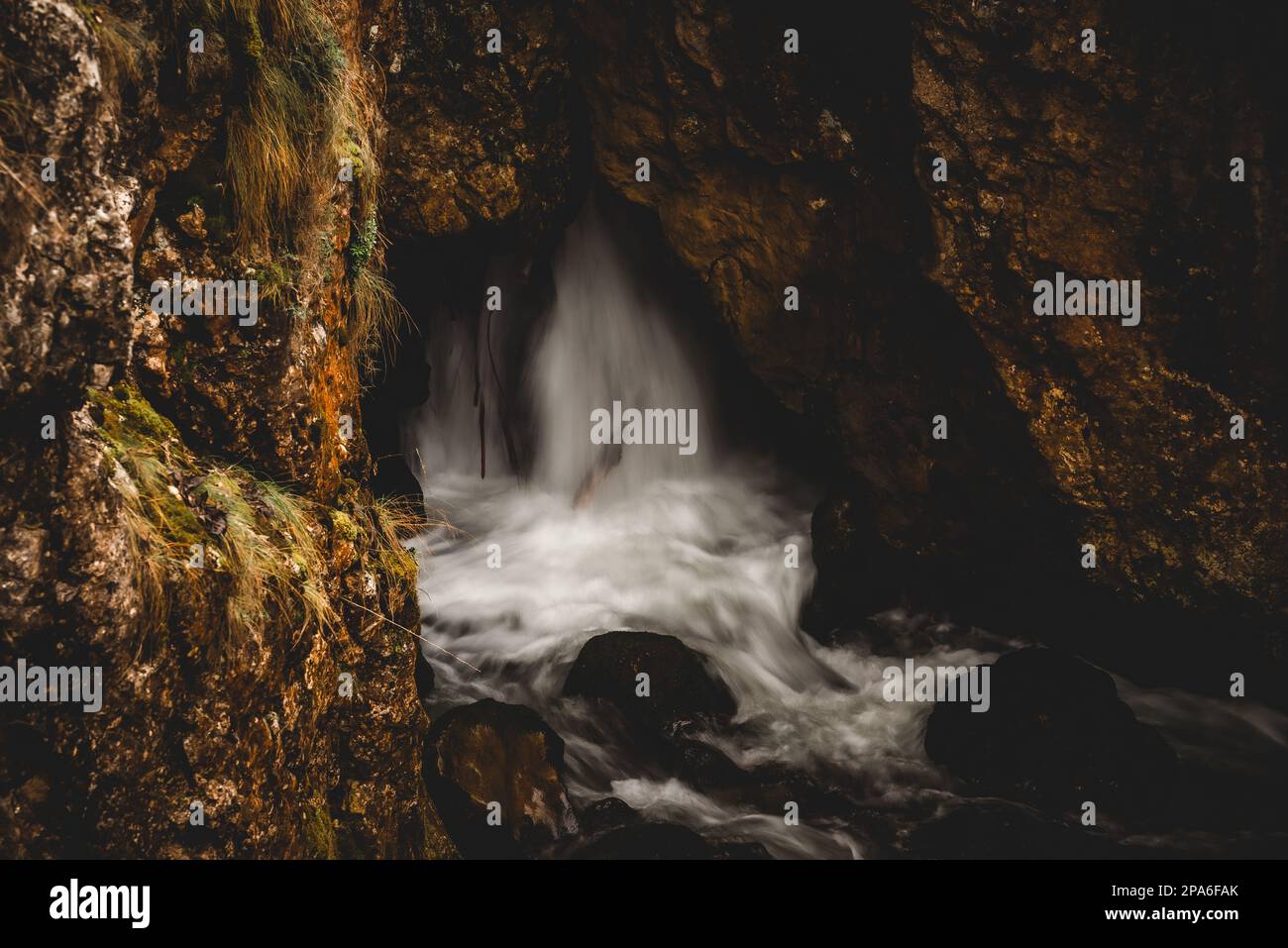 An image of a waterfall cascading out of a moss-covered cave Stock ...