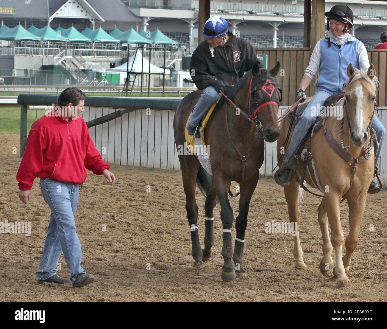 Trainer Tim Kasparoff, left, talks with jockey Richard Migliore as he ...
