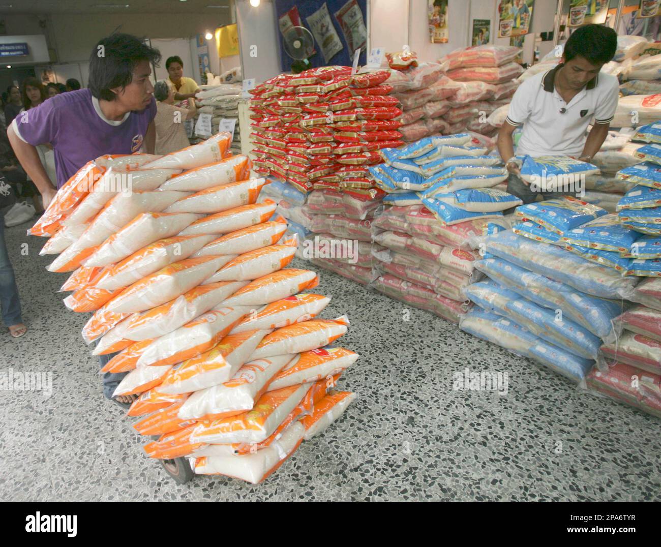 Thai worker loads a rice sack for sale at the Department of Internal ...