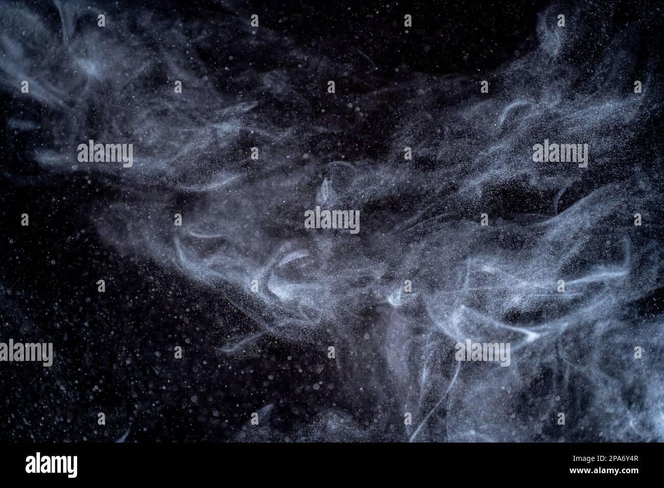 Dust particles cloud generating abstract shape on black background with ...