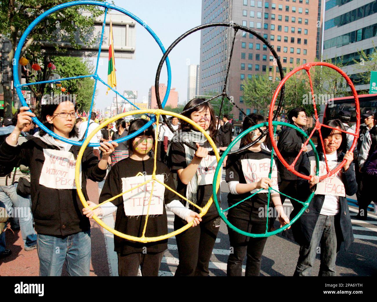 Pro-Tibet protesters show an Olympic mark made of peace signs during an ...