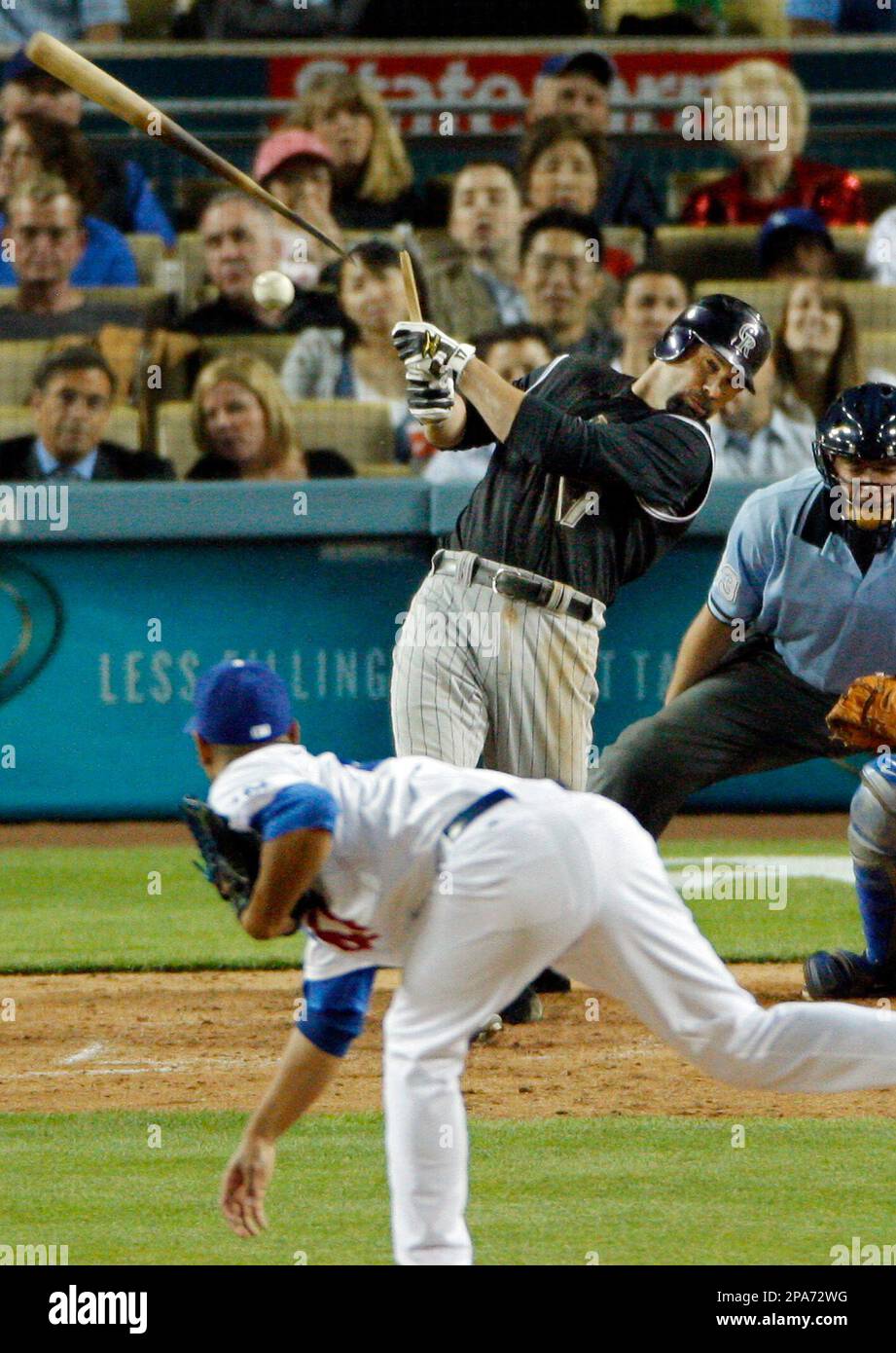Colorado Rockies' Todd Helton breaks his bat for a base hit as Los ...