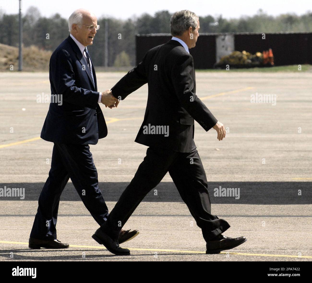 President Bush holds hands with Rep. Christopher Shays, R-Conn. prior ...
