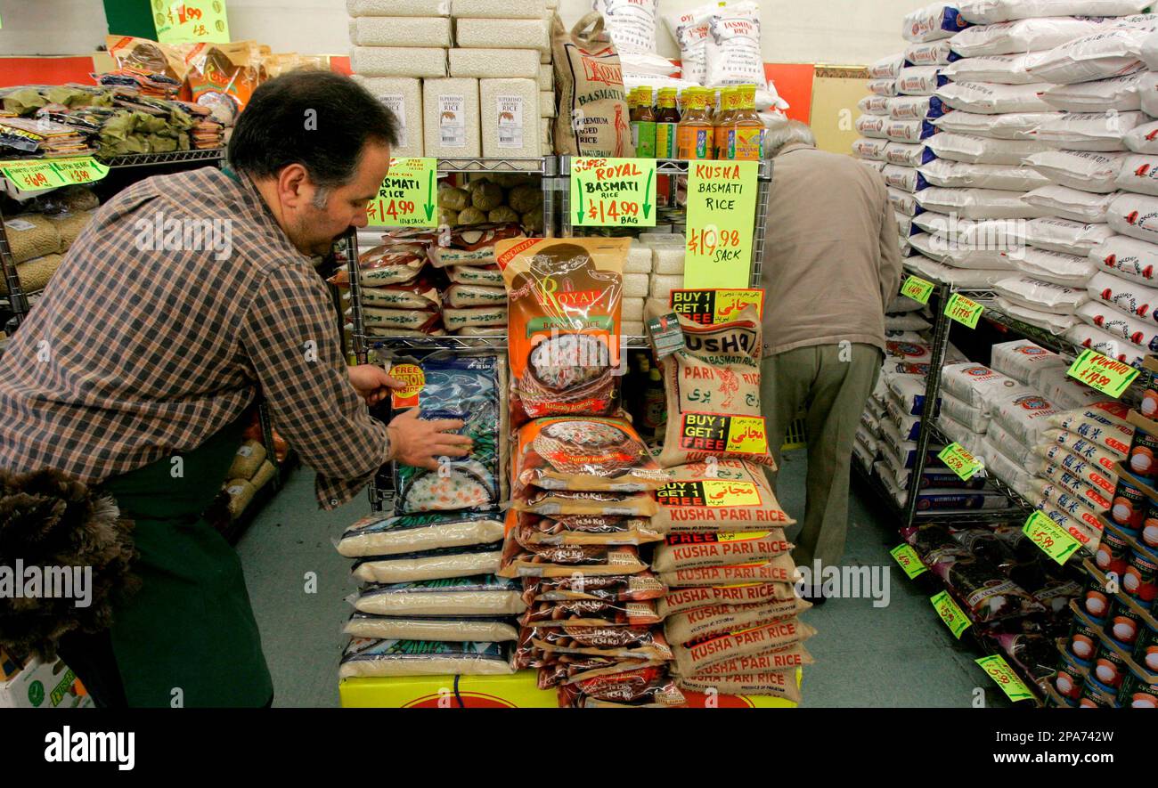 Christos Angelopoulos, left, manager of 22nd & Irving Market, stacks ...