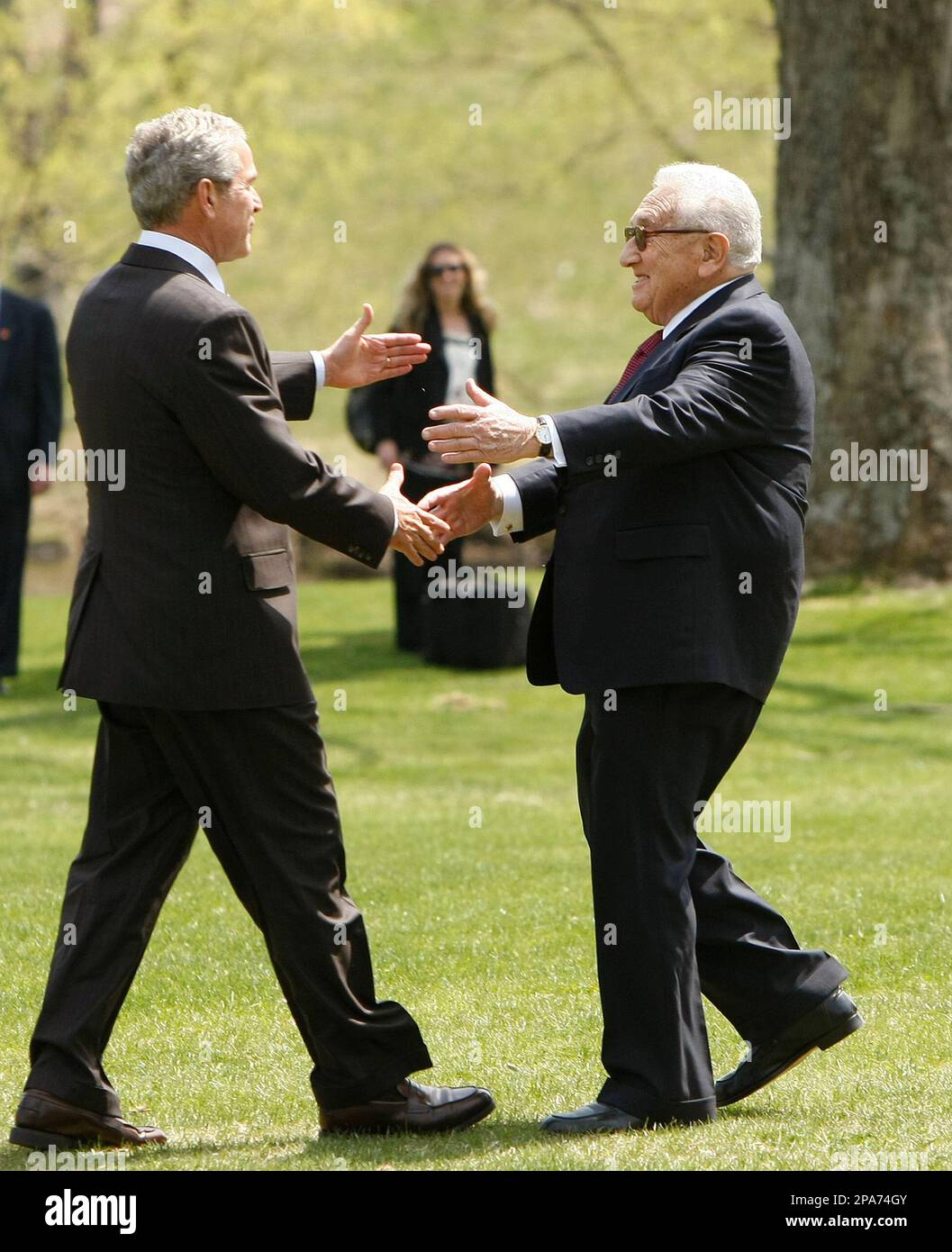 President Bush is greeted by former Secretary of State Henry Kissinger ...