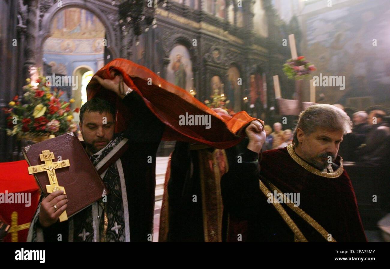 Orthodox priests carry a pall during a mass at Virgin Mary cathedral in ...
