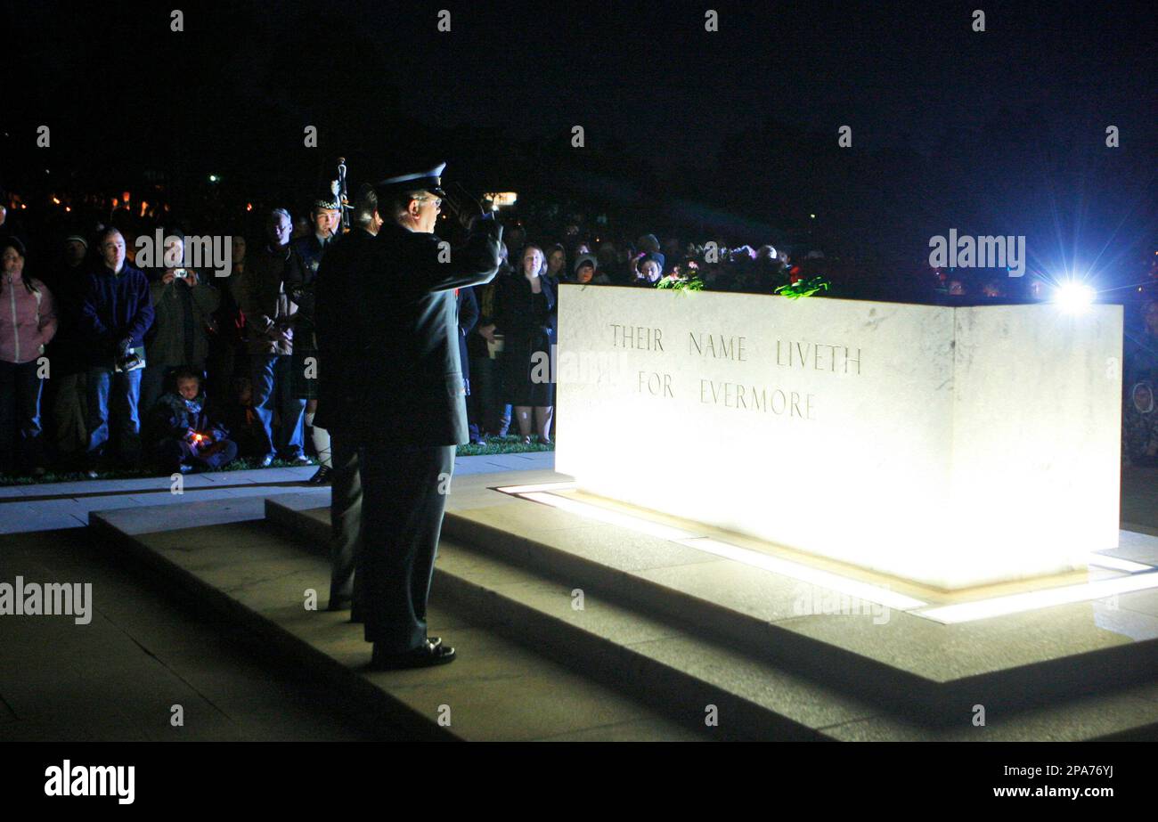 A soldier pays his respects at the Remembrance Stone at the War ...
