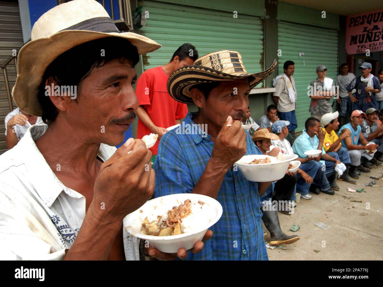 Coca farmers have lunch during their fifth day of protests in Taraza ...