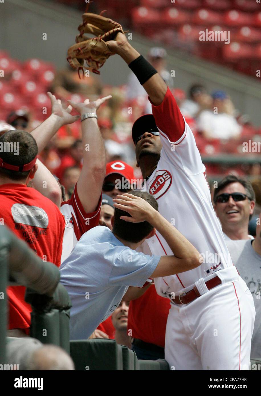 Cincinnati Reds third baseman Edwin Encarnacion, right, catches a foul ...