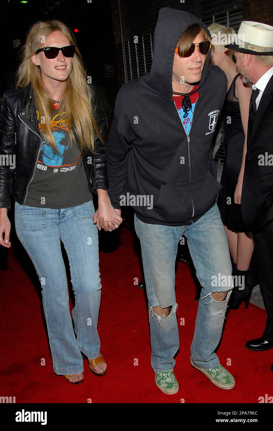 Singer Evan Dando, right, and model Elizabeth Moses walk the press line ...