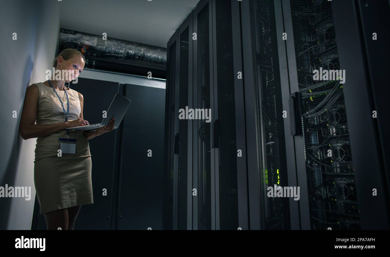 It Engineer Standing Amid Working Server Racks Doing Routine
