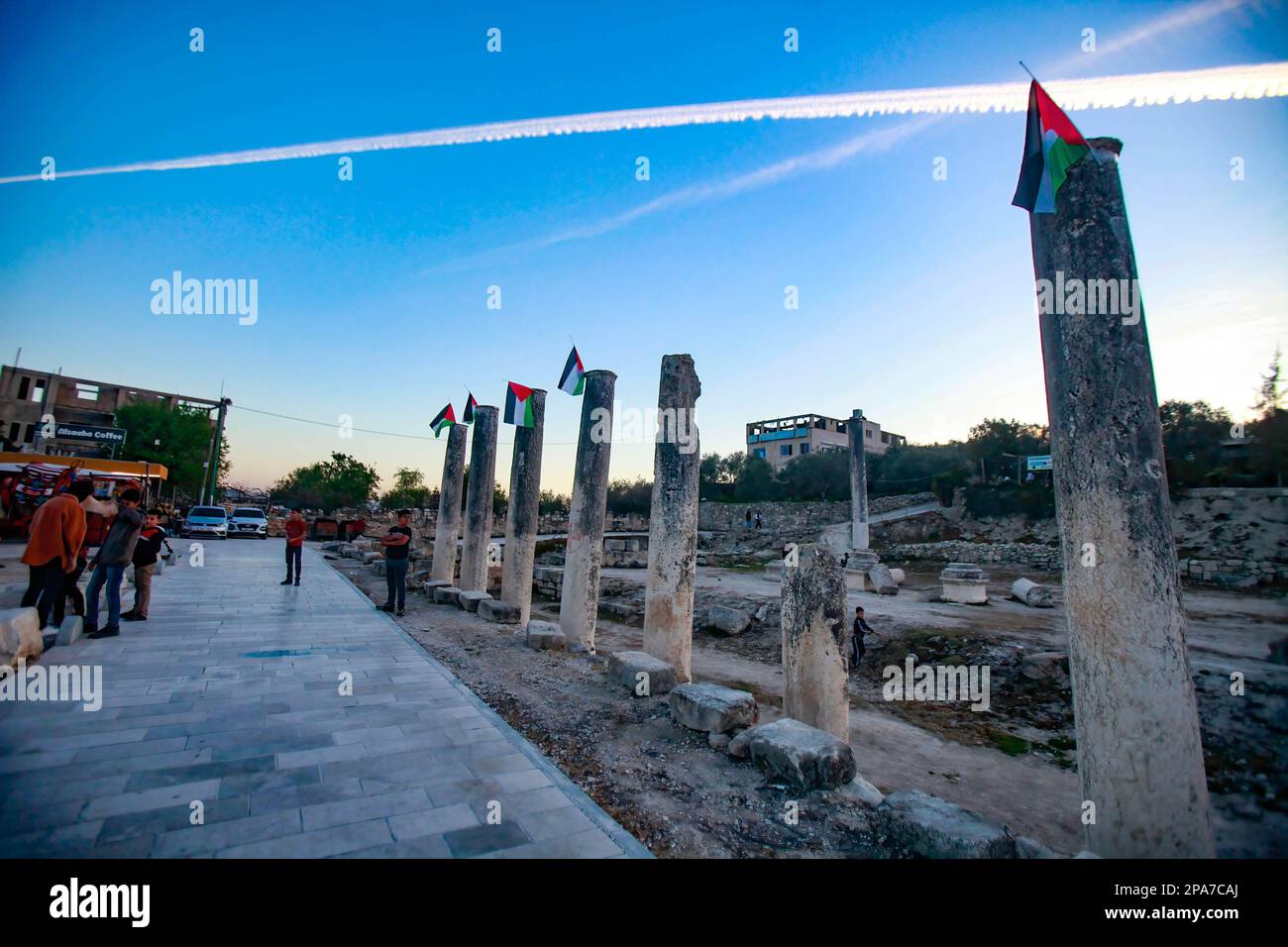 Kids are seen playing next to Palestinian flags at an archaeological ...