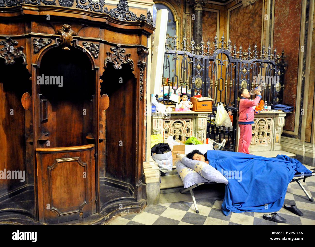 An homeless woman sleeps inside the 14th century "Basilica del Carmine ...
