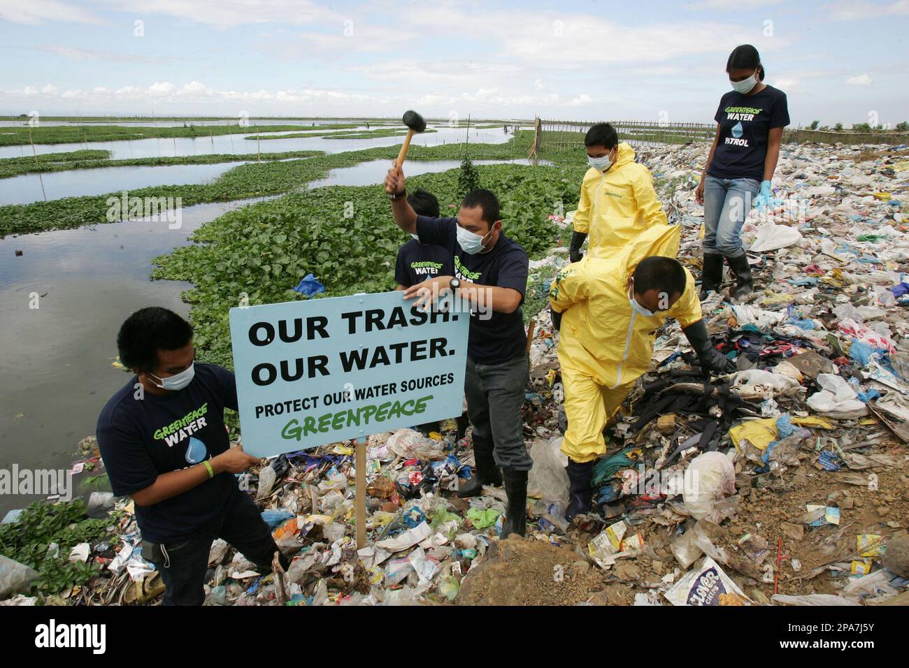 Greenpeace activists put up a sign after taking water samples to ...