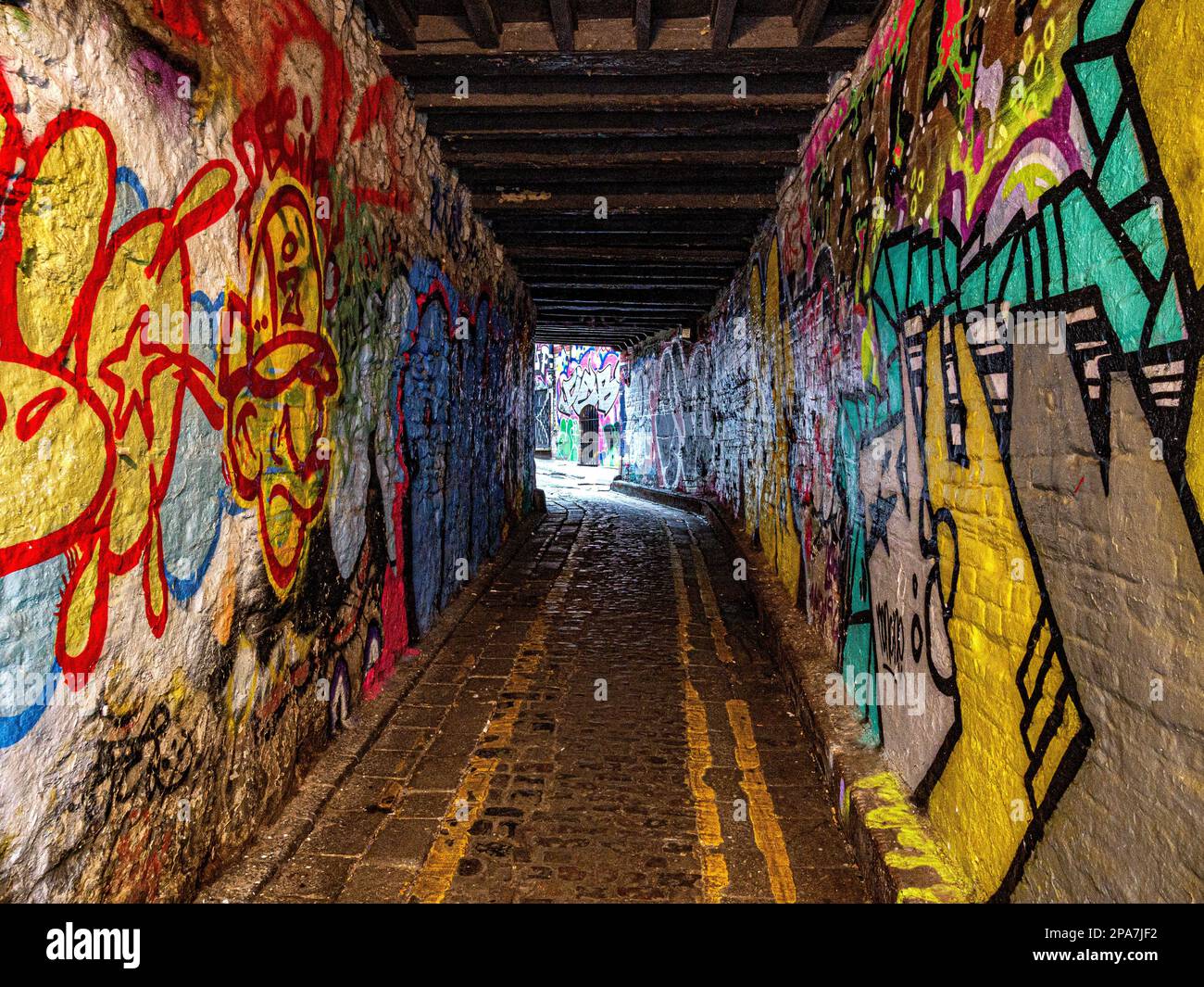 Colourful graffiti covered walls of a narrow alley off Corn Street in ...