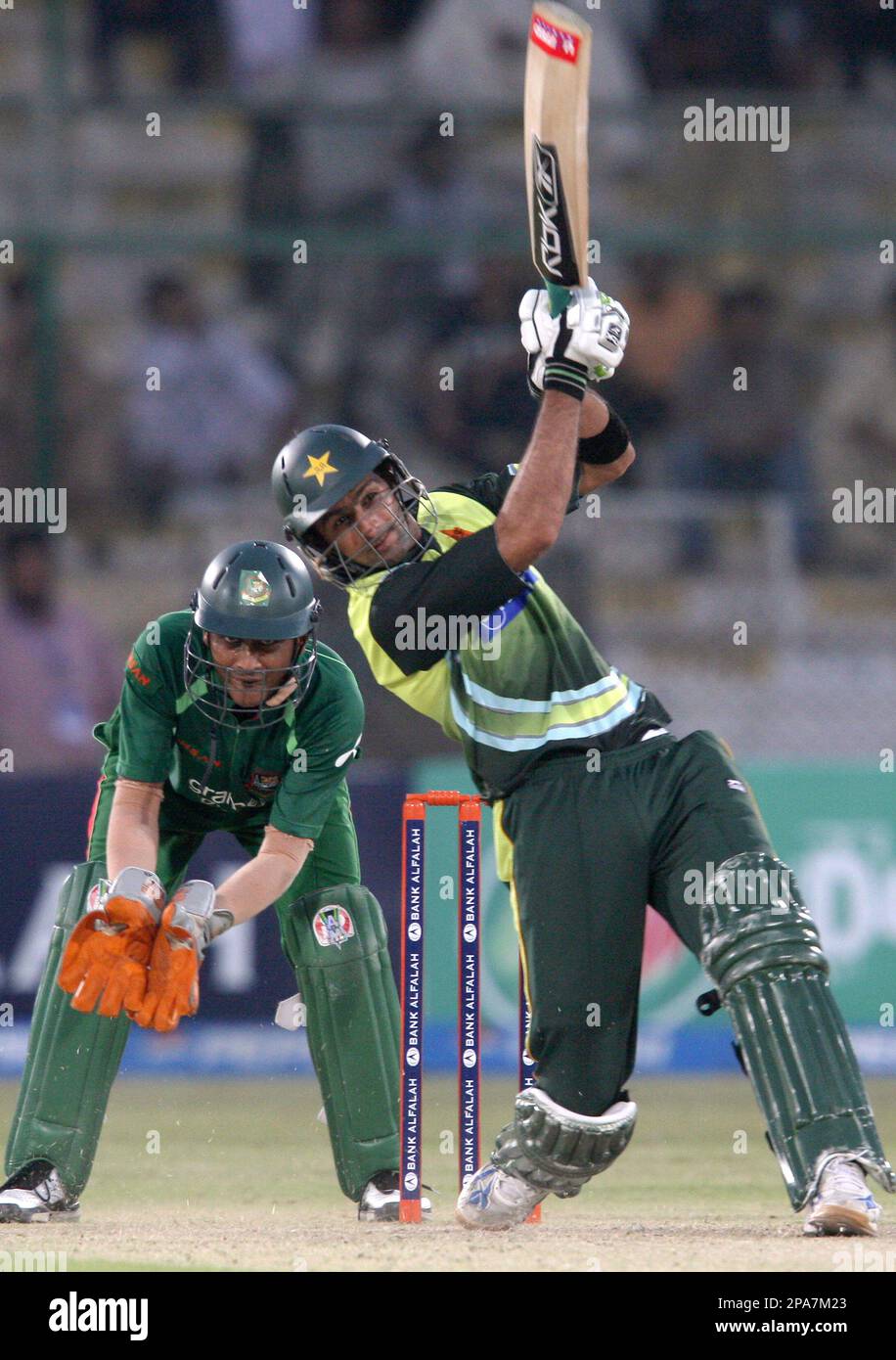 Pakistani batsman Shoaib Malik plays a shot as Bangladeshi wicketkeeper Dhiman Ghosh looks on ...