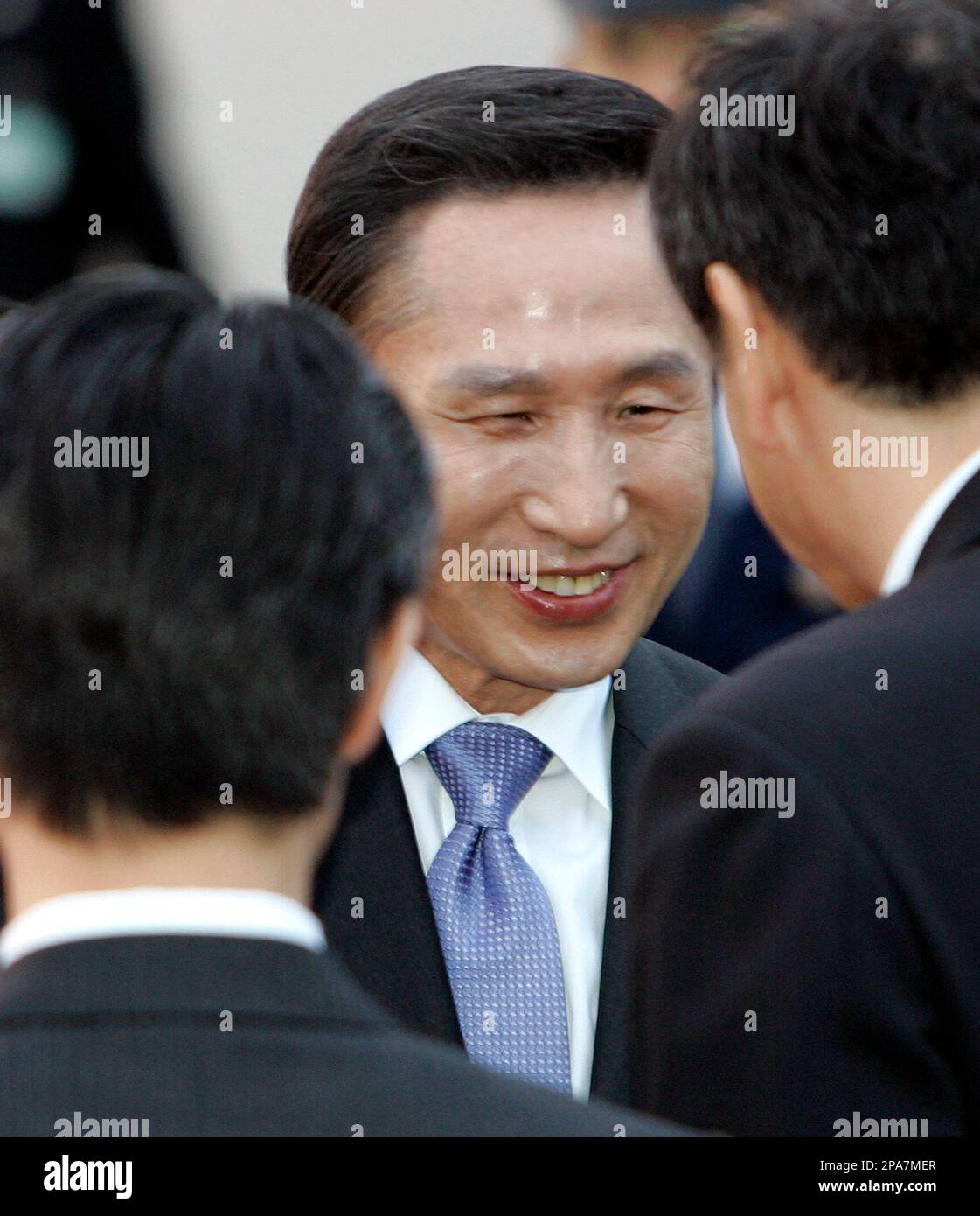 South Korean President Lee Myung-bak, center, is greeted by South Korea ...