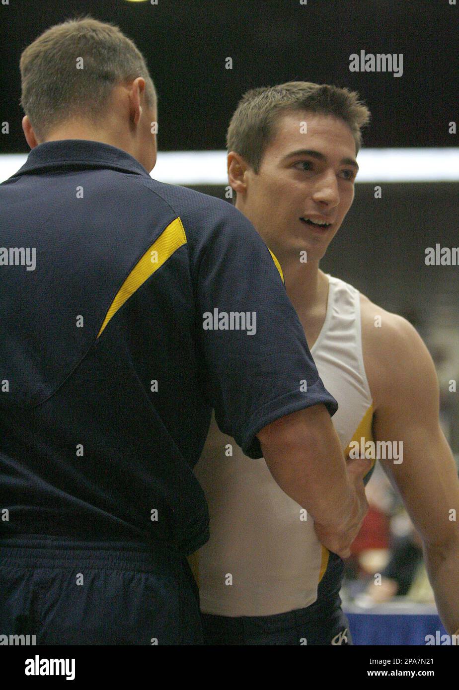 California's Tim McNeil, right, hugs one of his coaches after competing ...