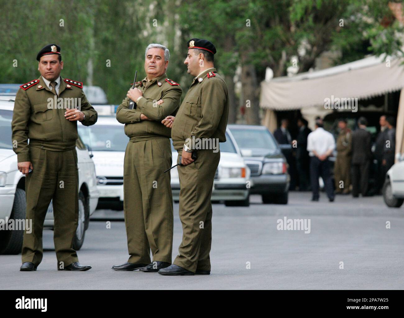 Syrian police officers, stand guard as they secure the area where the ...